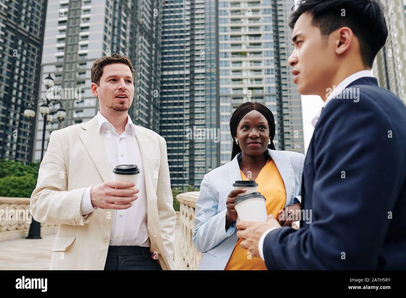 Investors meeting with developer at construction site of new city ...