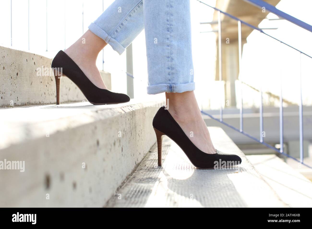 Side view close up of a woman legs wearing high heels walking down ... Side view close up of a woman legs wearing high heels walking down ...