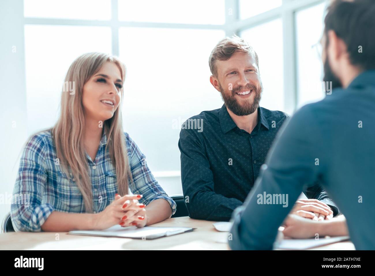 group of business people conducting an interview sitting at the table ...