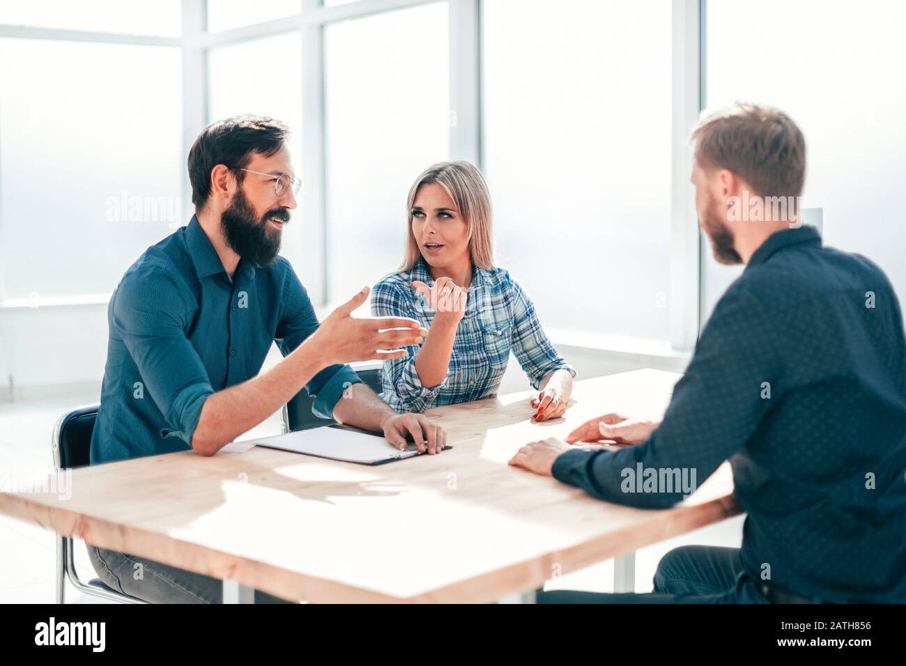 managers and job seeker sitting at the table during the interview Stock ...