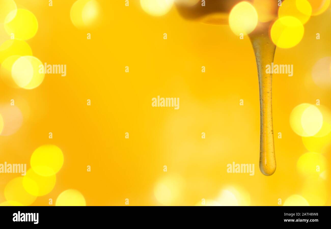 Honey flow dropping. Sweet amber flower honey flows with copy space ...