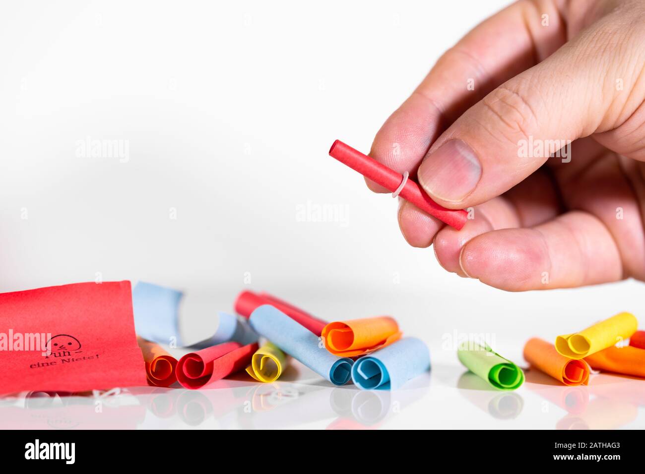 male hand with many colorful opened and unopened raffle tickets Stock ...