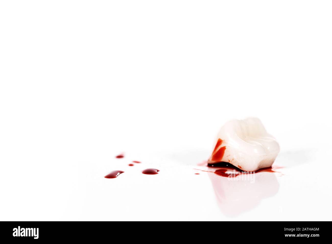 Concept image with bloody tooth in front of white background Stock ...