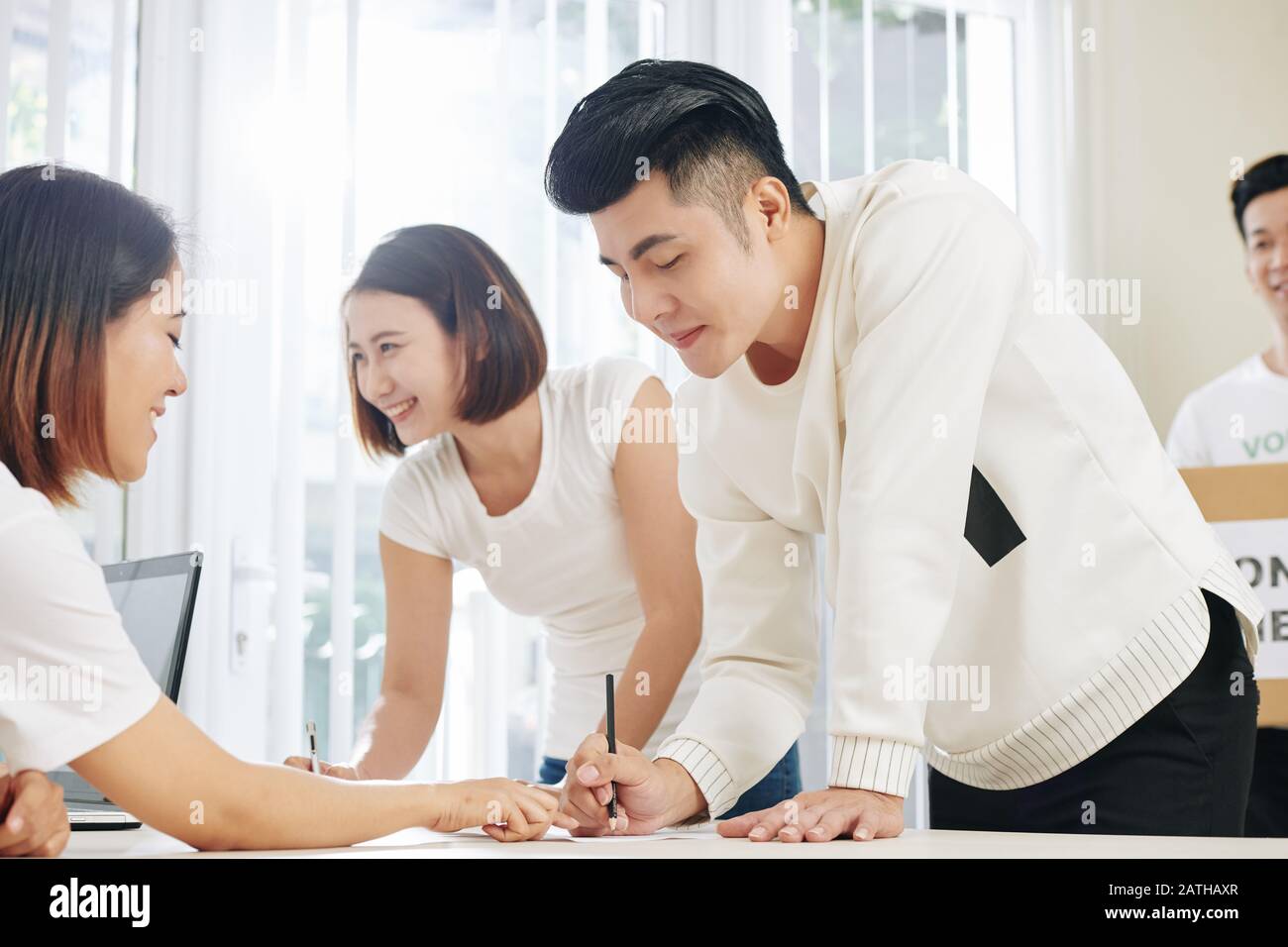 Young people registrating and writing down their names in volunteer ...