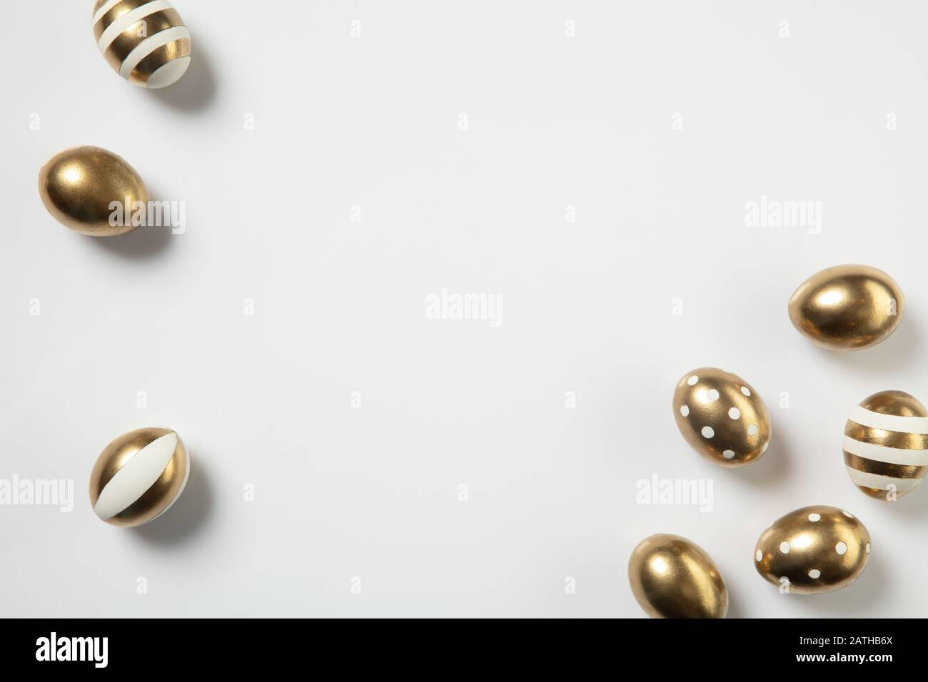 Egg hunt is coming. Easter traditions, golden colored eggs on white ...