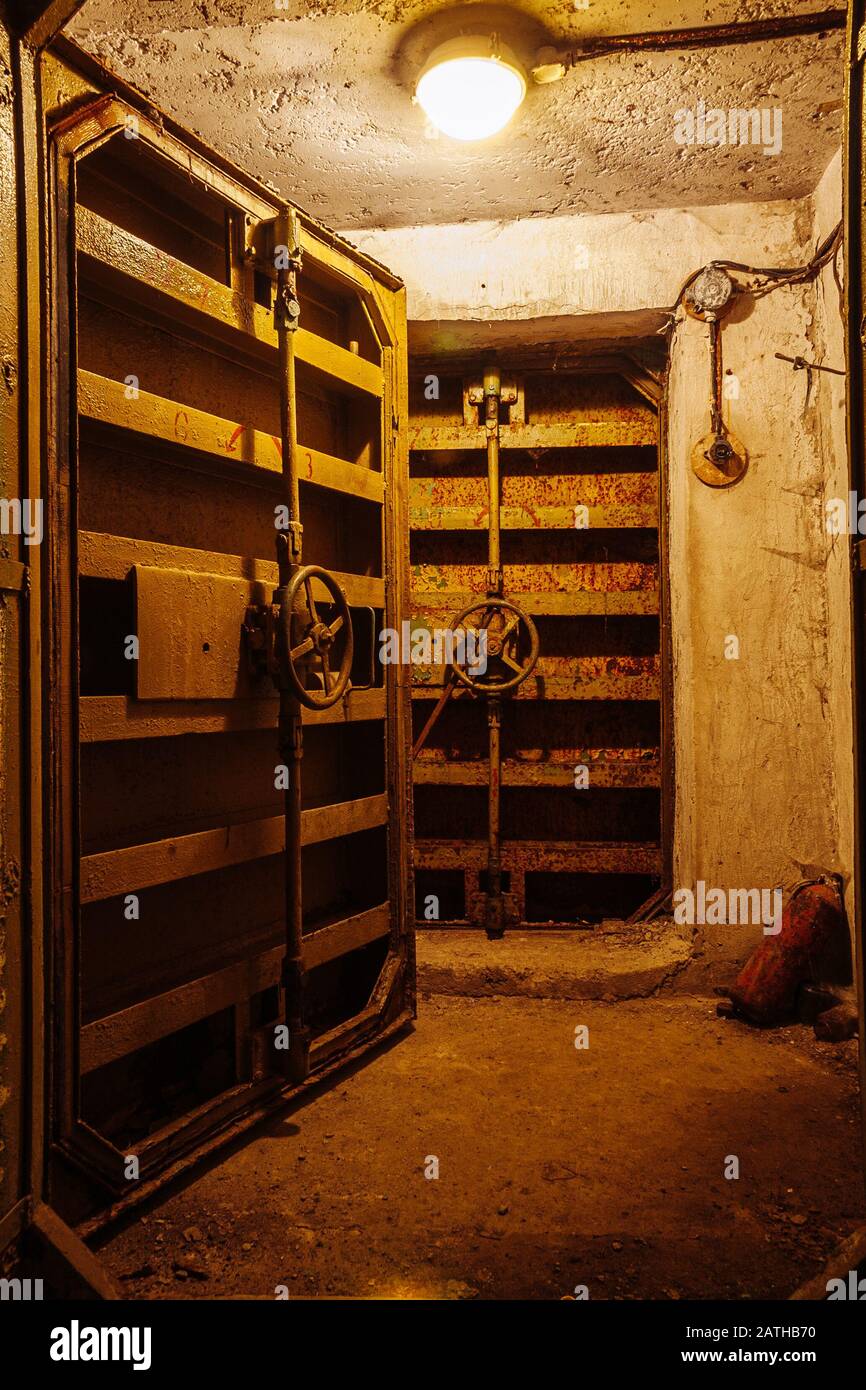 Old hermetic metal armored door with valve, entrance of bomb shelter ...
