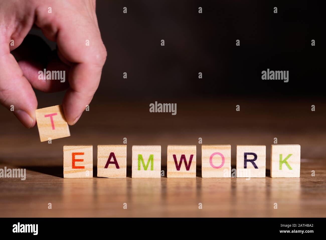 Hand put wooden blocks with letters in a row, word Teamwork Stock Photo ...