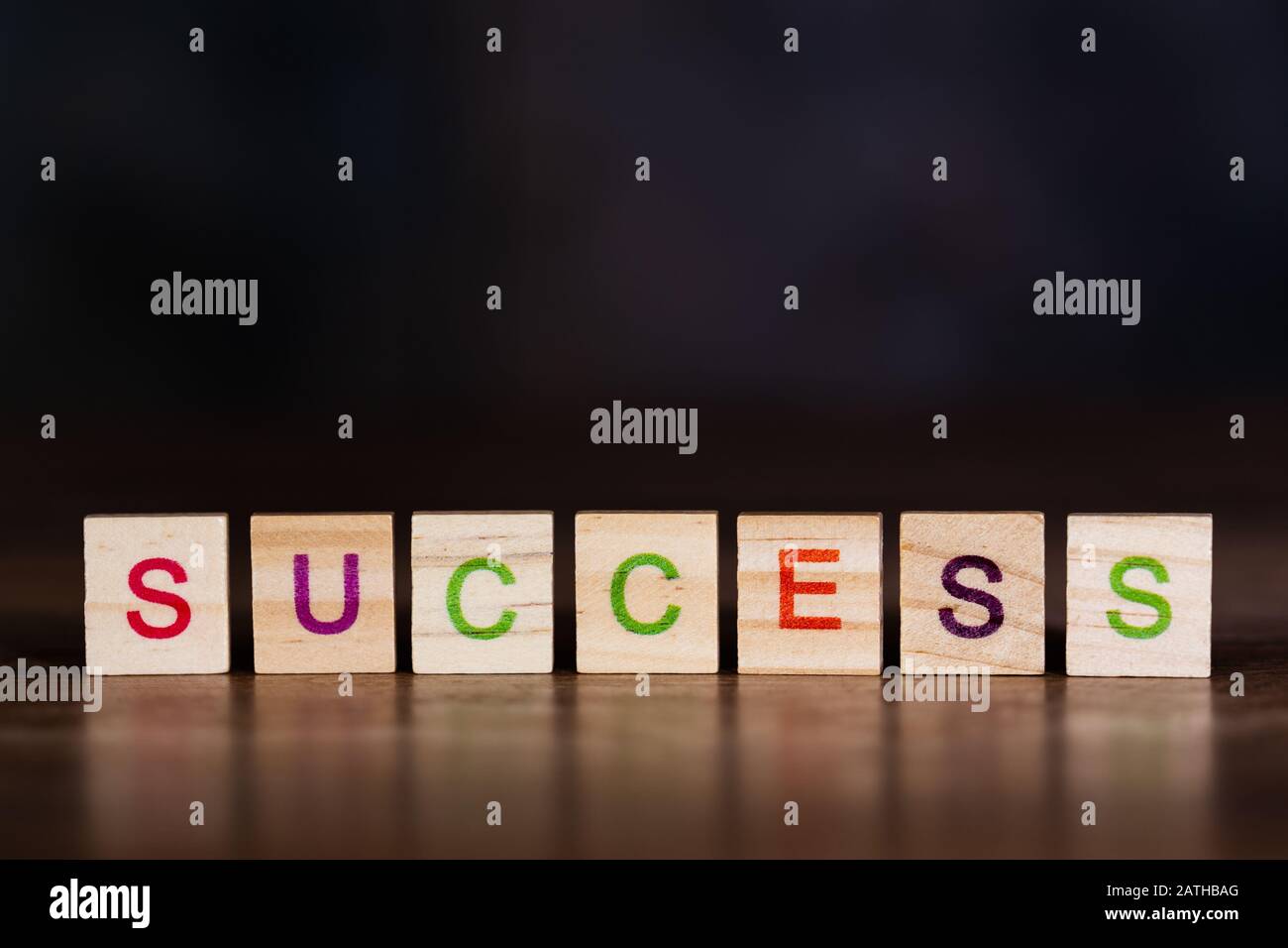 The word success, made up of many colorful letters on wooden blocks ...