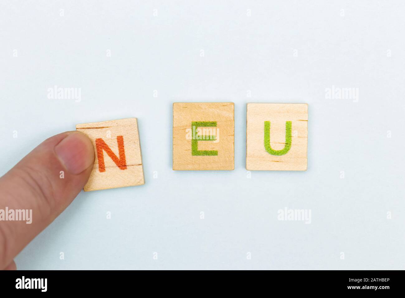 Top view of a finger sliding the letter N on the letters EU, concept ...