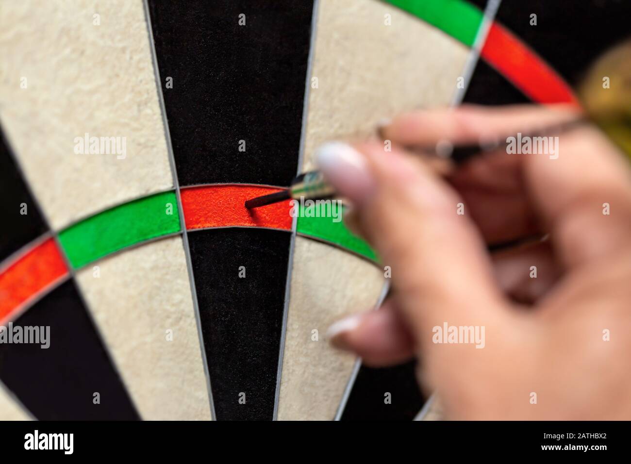 Woman playing dart, professional steeldart sport, closeup dartboard and ...