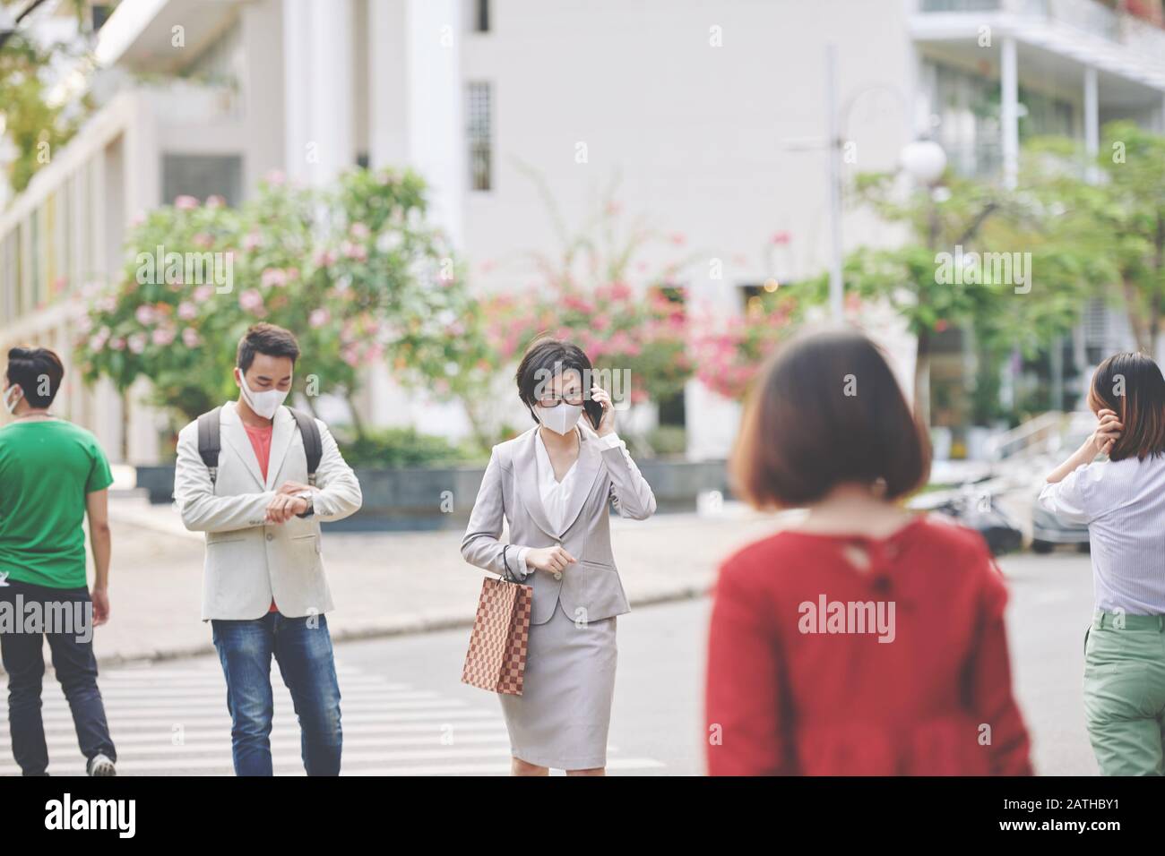 Asian people walking in quarantined city street with medical masks on ...