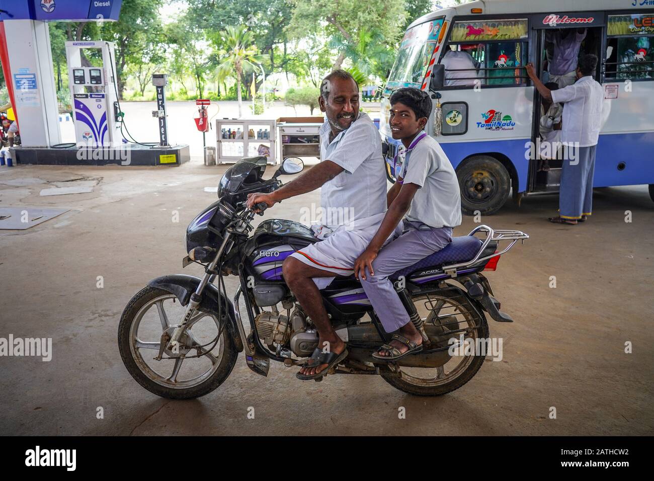 Portraits of riders of motorcycles and mopeds at a petrol station near ...