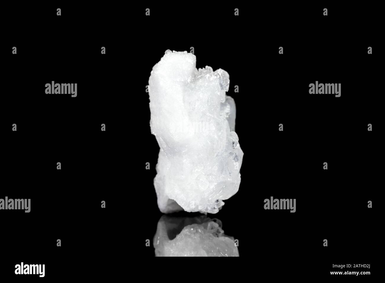 Raw milk quartz mineral stone in front of black background, mineralogy ...