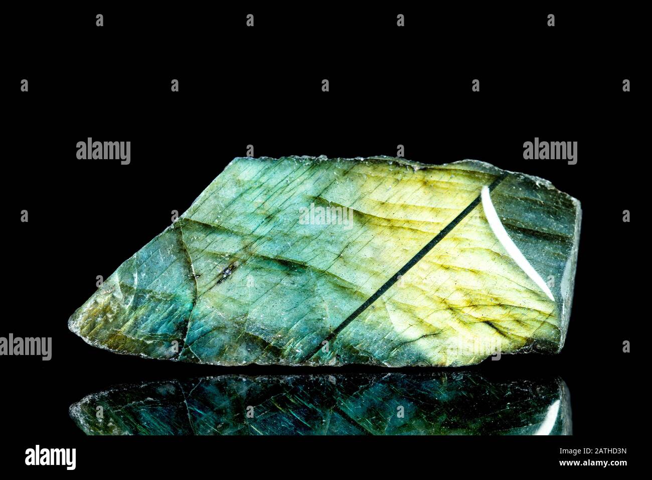 Raw labradorite mineral stone in front of black background, mineralogy ...