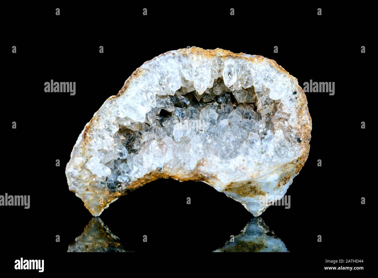 Raw quartz druse or geode mineral stone in front of black background ...