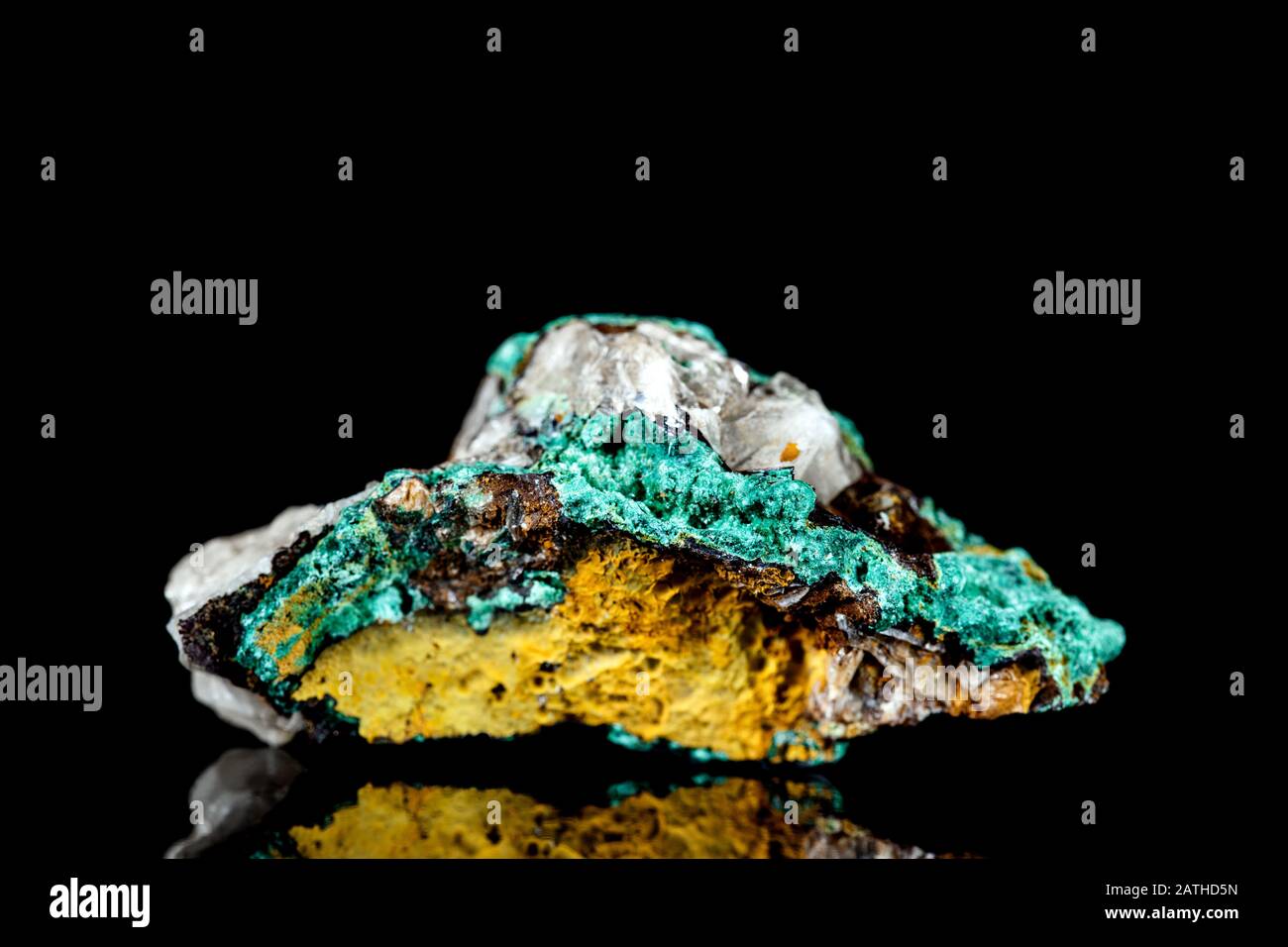 Raw malachite mineral stone on mother rock in front of black background ...