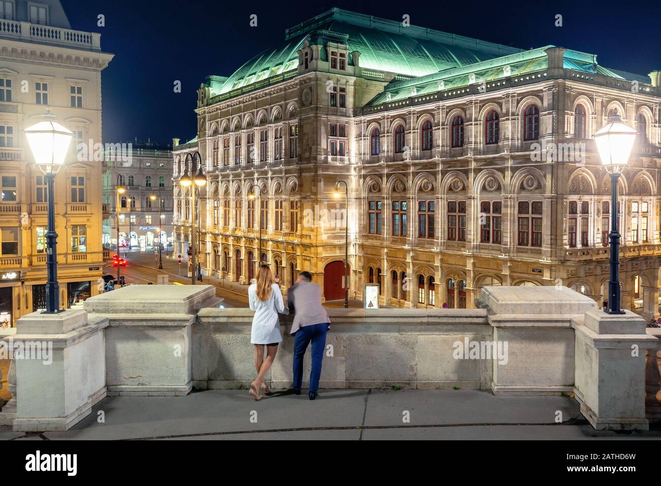 couple on the balcony of albertina enjoy the view. beautiful cityscape ...