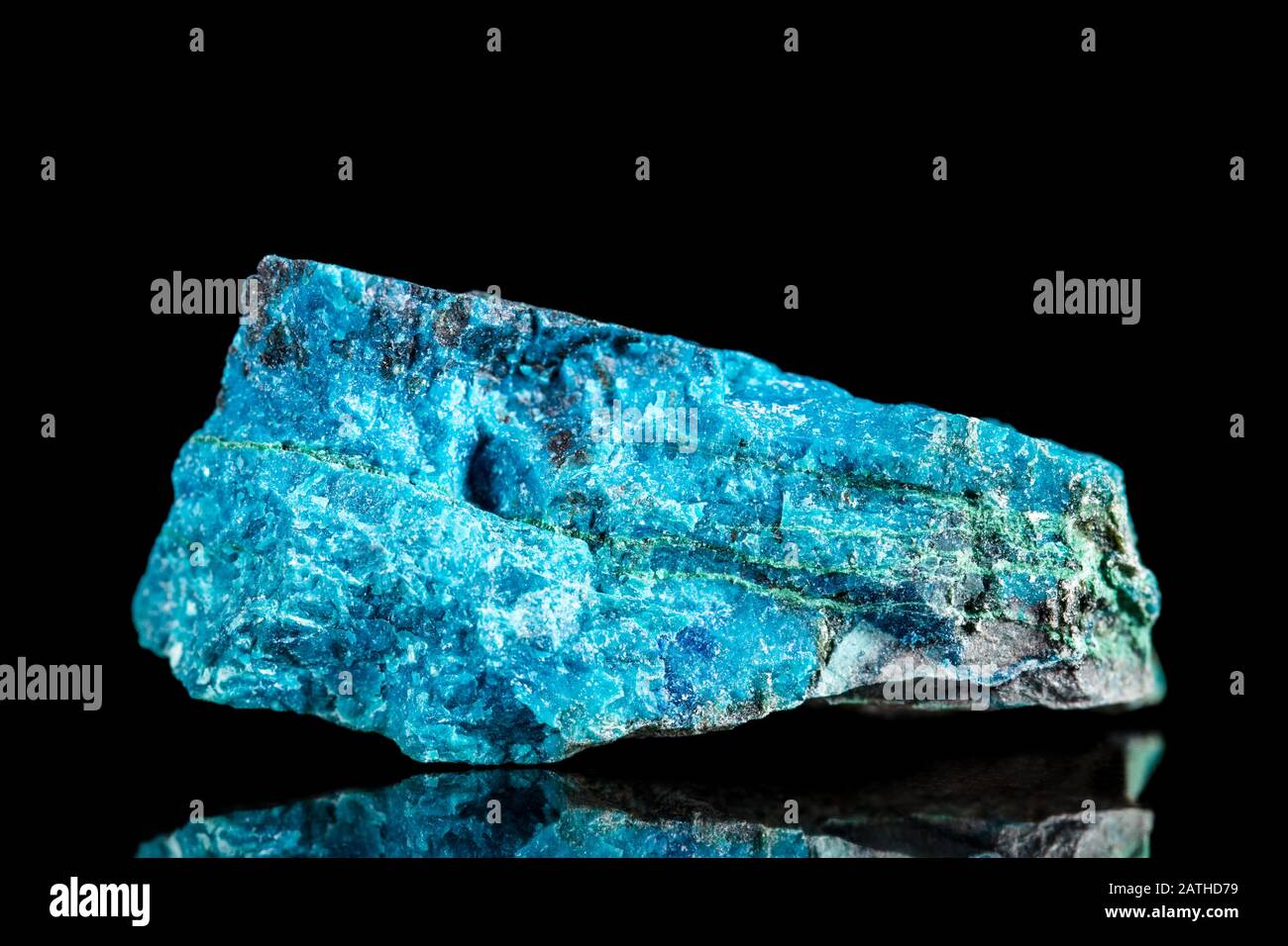 Raw blue apatite mineral stone in front of black background, mineralogy ...