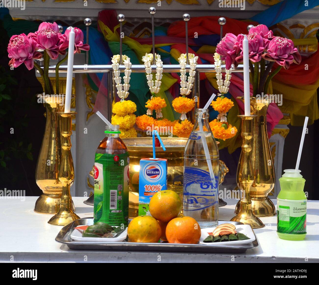 Offerings on a typical Thai spirit house or shrine outside a hotel in ...