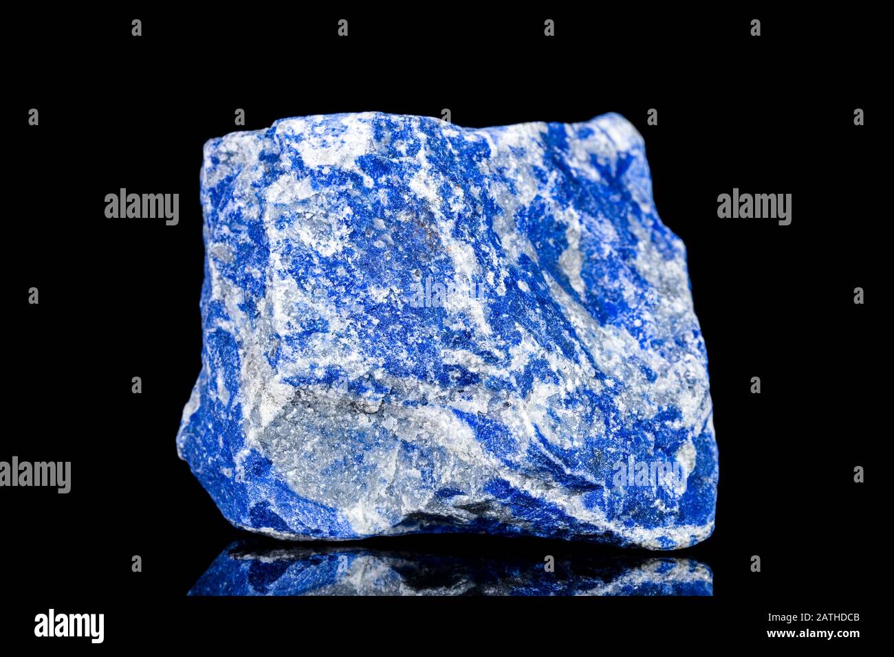 Raw blue lapis lazuli mineral stone in front of black background ...