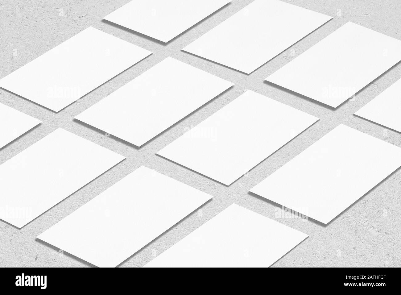 Closeup of empty white rectangle business card mockups lying diagonally ...