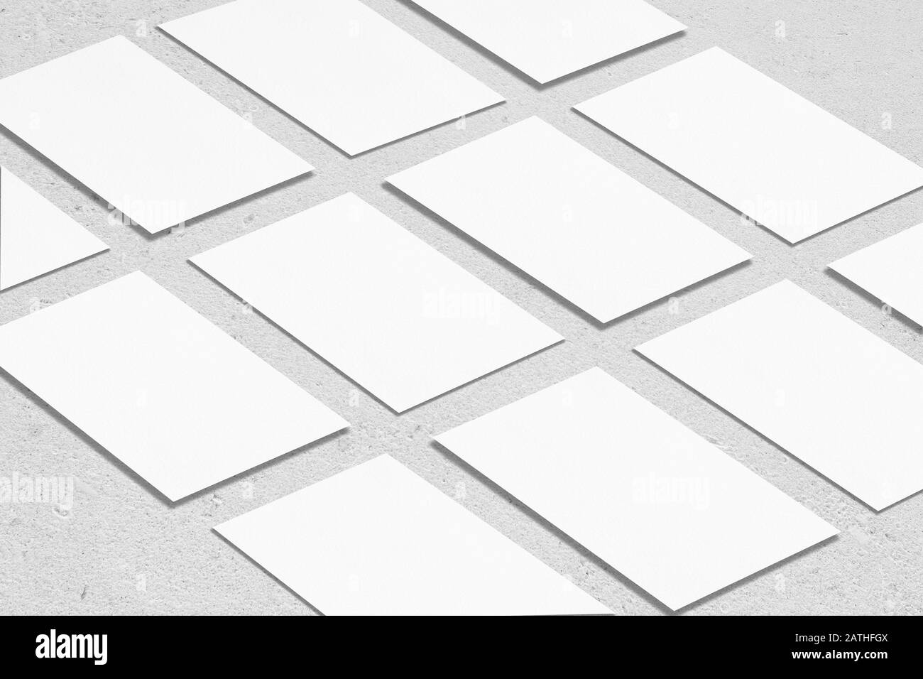 Closeup of empty white rectangle business card mockups lying diagonally ...