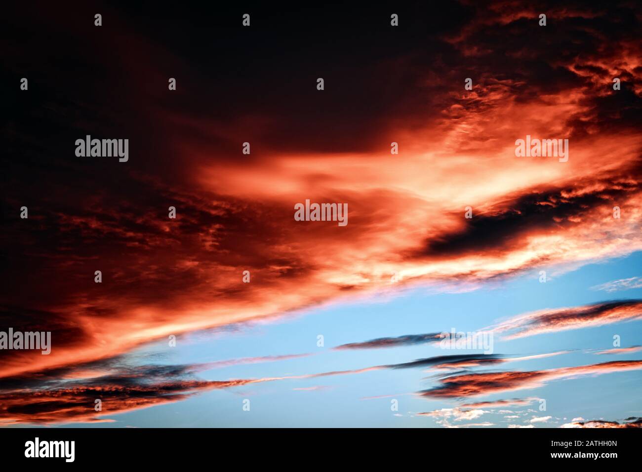 Stormy clouds over a blue sky, red and black storm or tempest ...