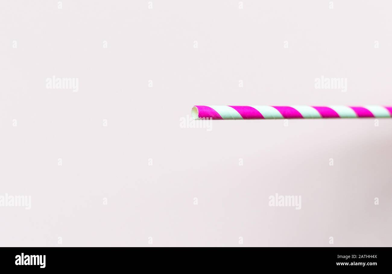 Pink straw on a pink background Stock Photo - Alamy