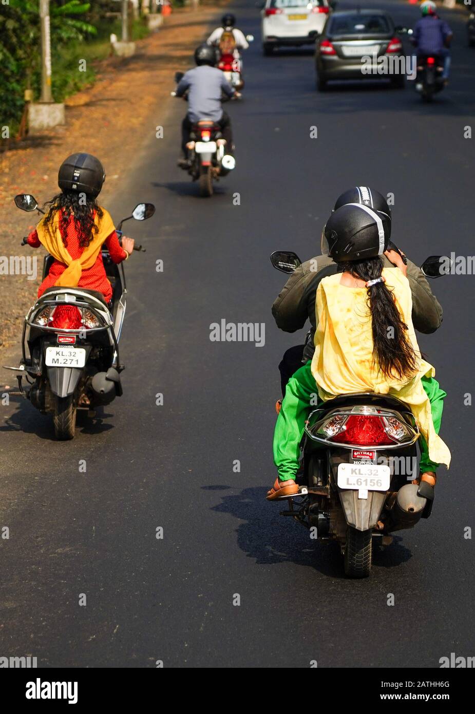 Views of riders of motorcycles and mopeds in Kerala. From a series of ...