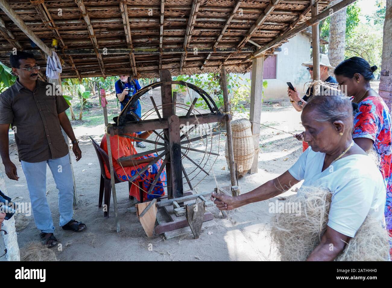 Locals demonstrating the making of rope from coconut hair. From a ...