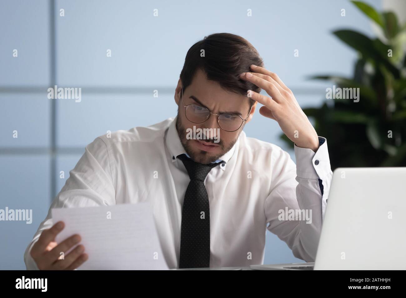 Concerned business owner reading letter from bank about financial ...