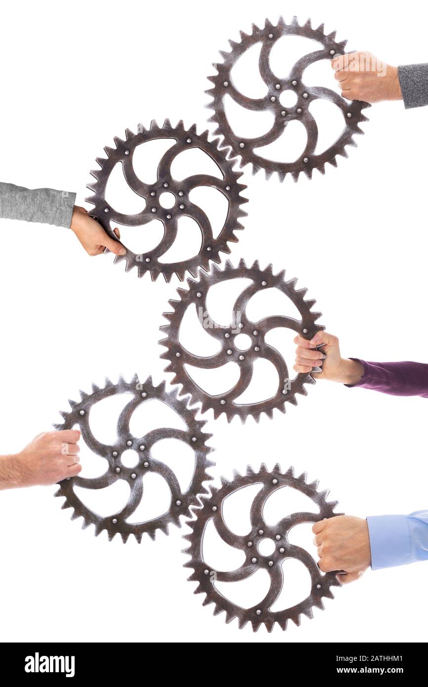 Many different hands hold gears that mesh. Group dynamics and ...