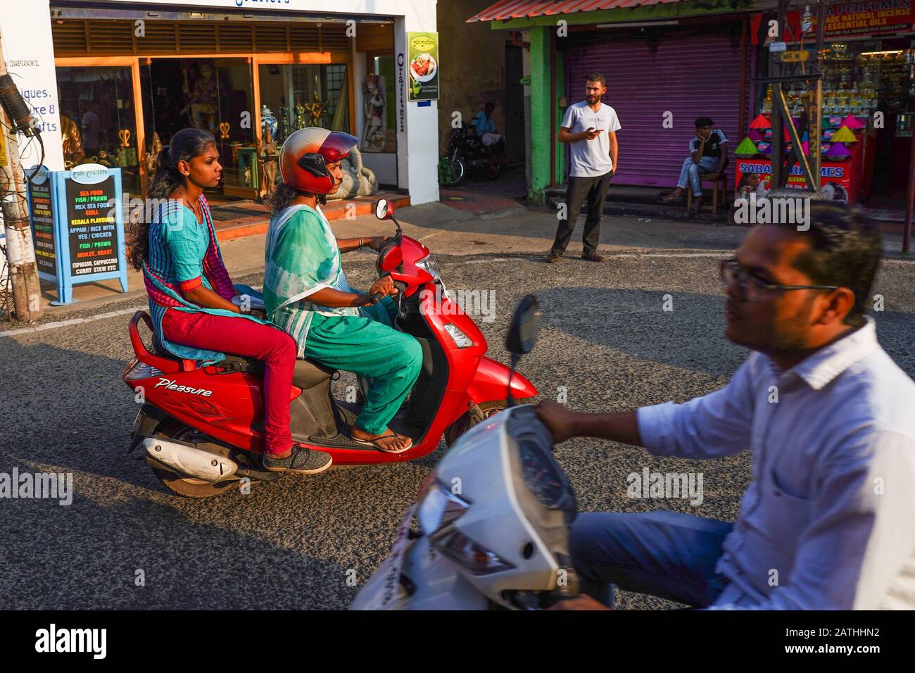 Views of riders of motorcycles and mopeds in Cochin, Kerala. From a ...