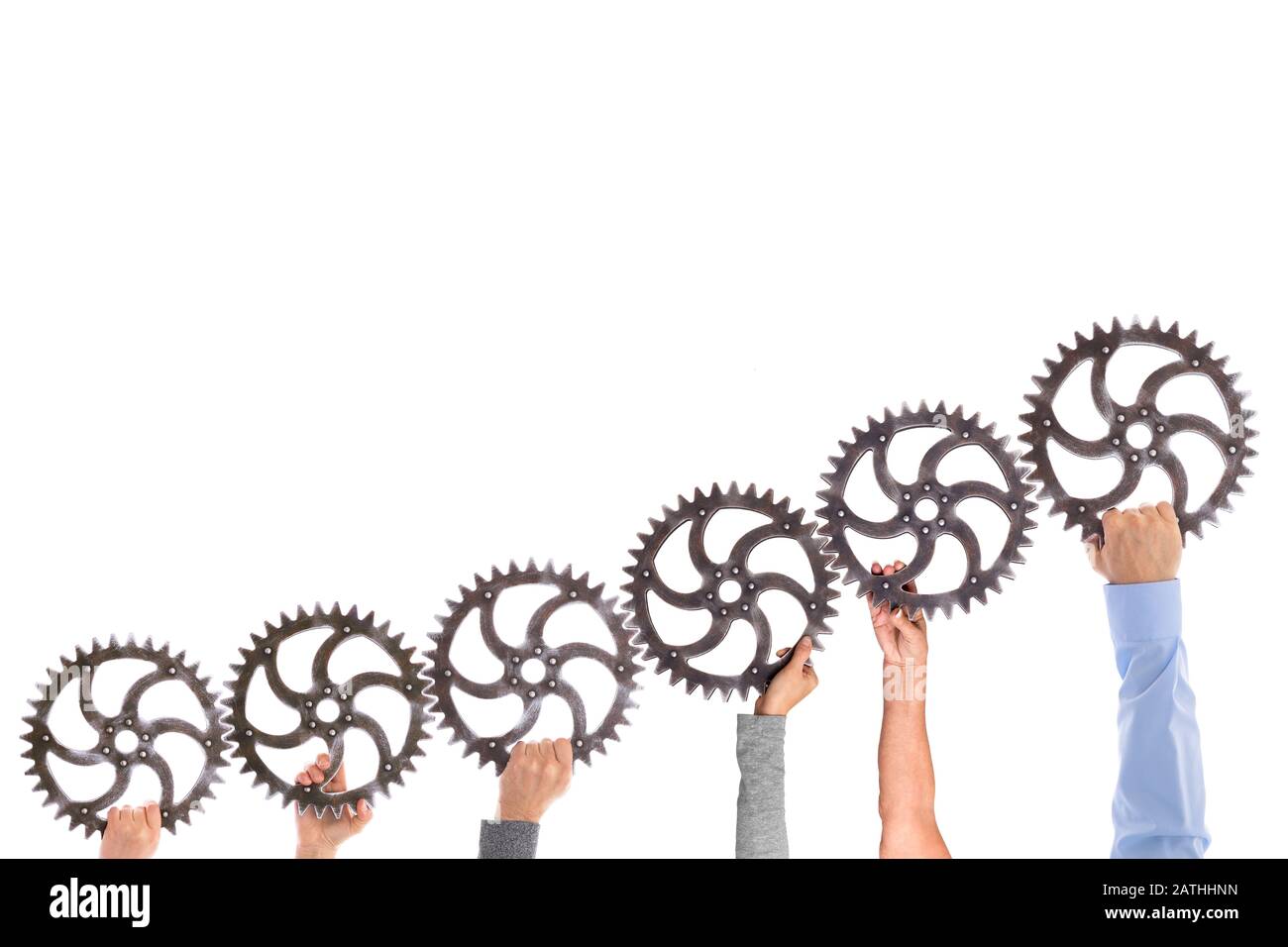Many different hands hold gears that mesh. Group dynamics and ...