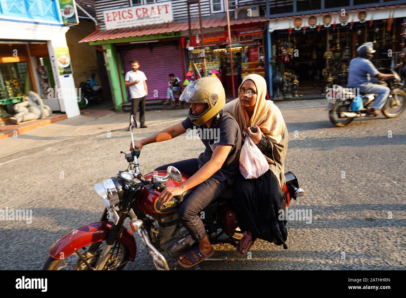 Views of riders of motorcycles and mopeds in Cochin, Kerala. From a ...