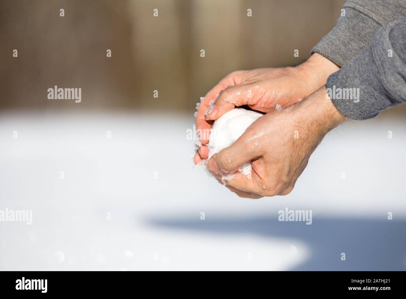 Hands forming a snowball, man in progress of a snowball fight, fun and ...