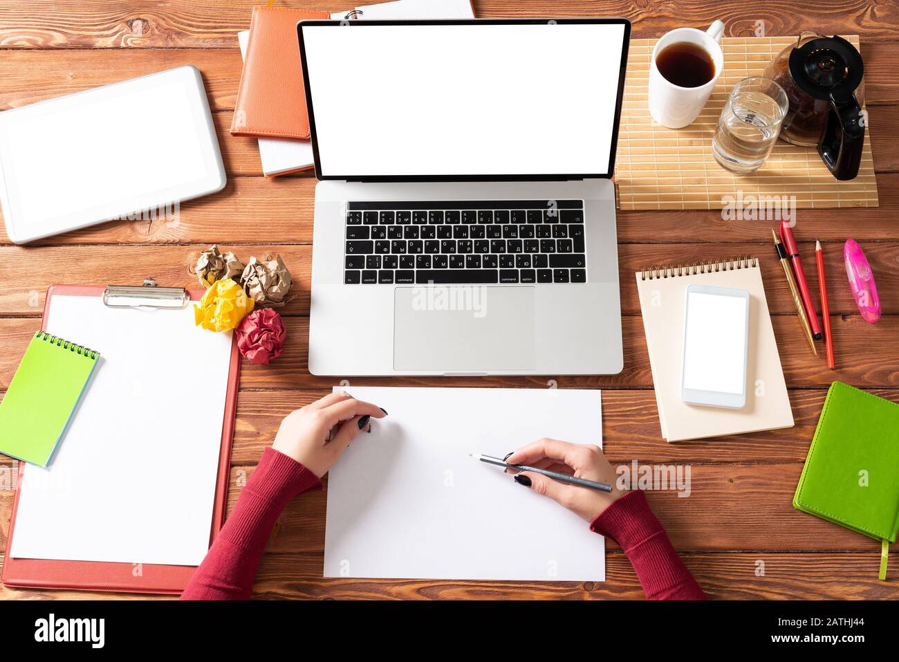 Female student taking notes with pen at desk Stock Photo - Alamy