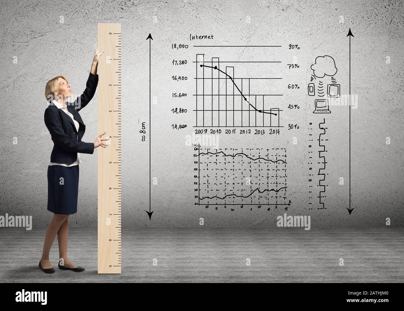 Woman in business suit holding big ruler Stock Photo - Alamy