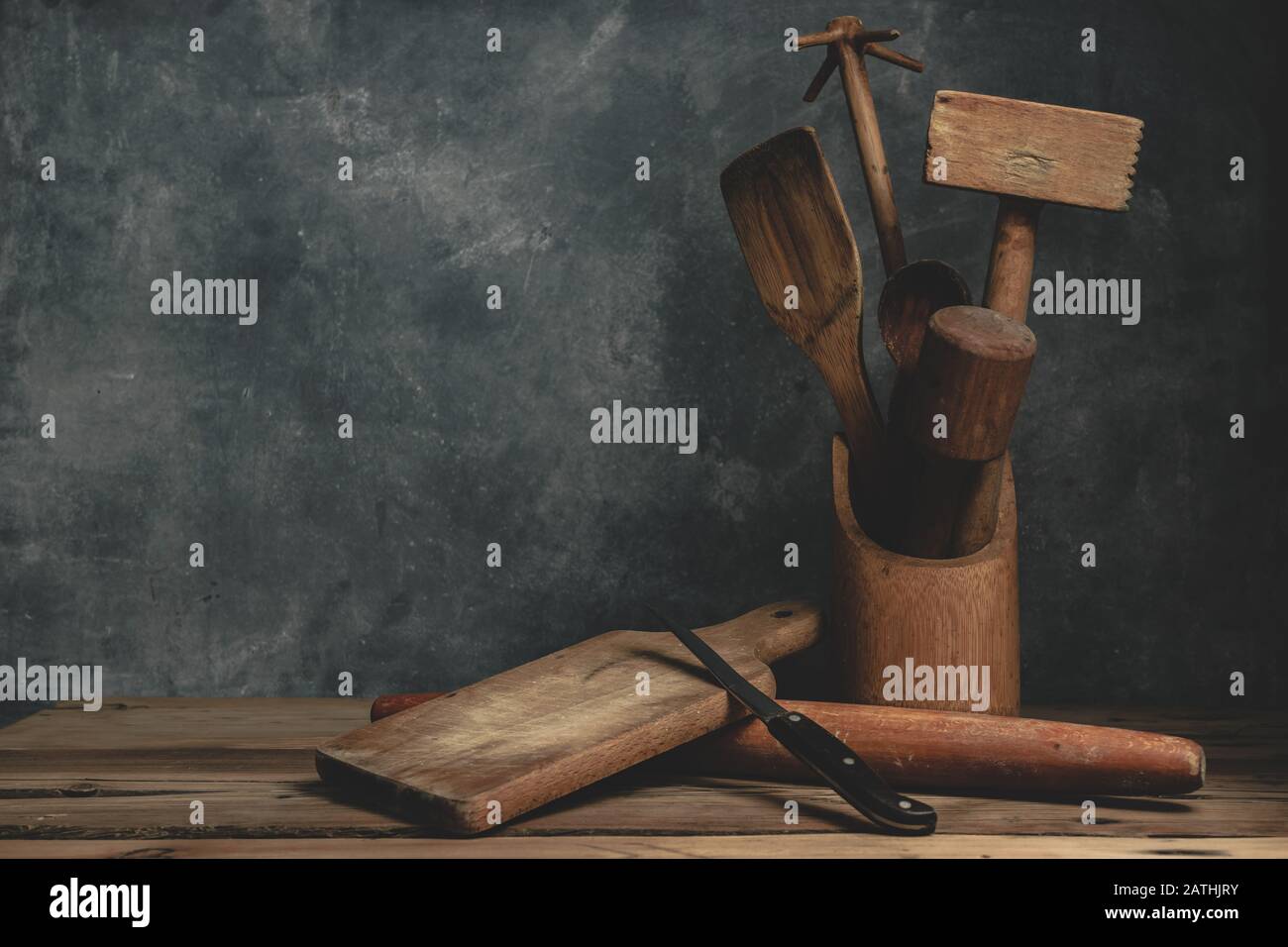 Beautiful vintage kitchen utensils on a oak wooden table and gray wall ...