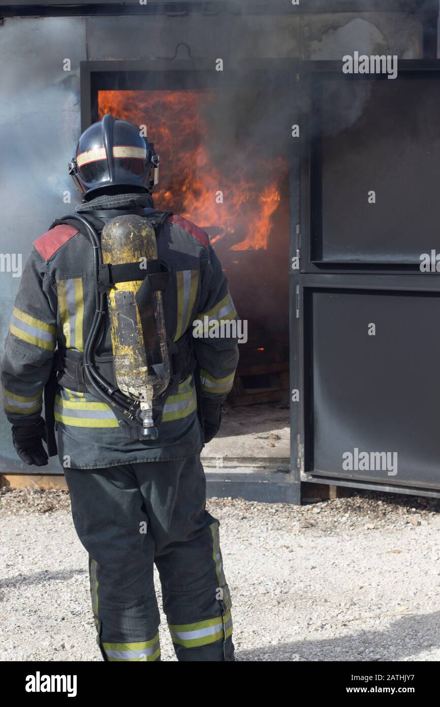 Firefighter putting out fire training station extinguisher backdraft ...