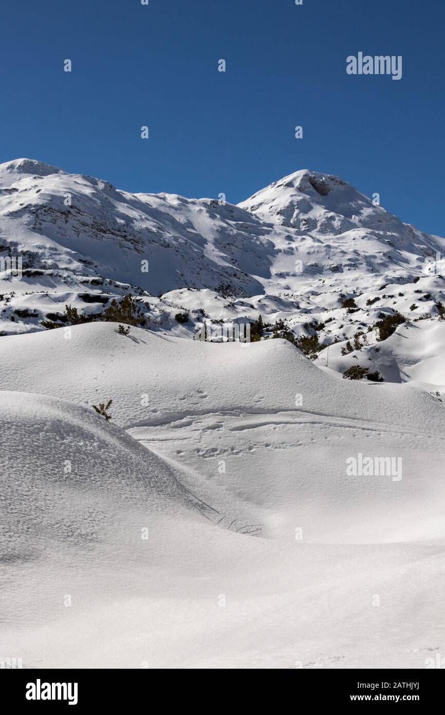 Pile of snow with high mountains, Komna plateau, Bohinj Stock Photo - Alamy