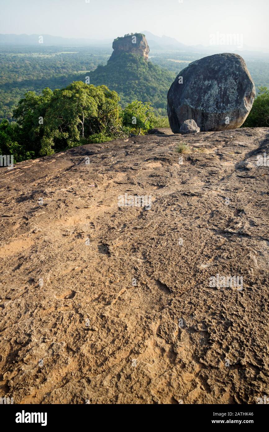 Big Stone on sunny orange Pidurangala Rock with view on Lions Rock ...