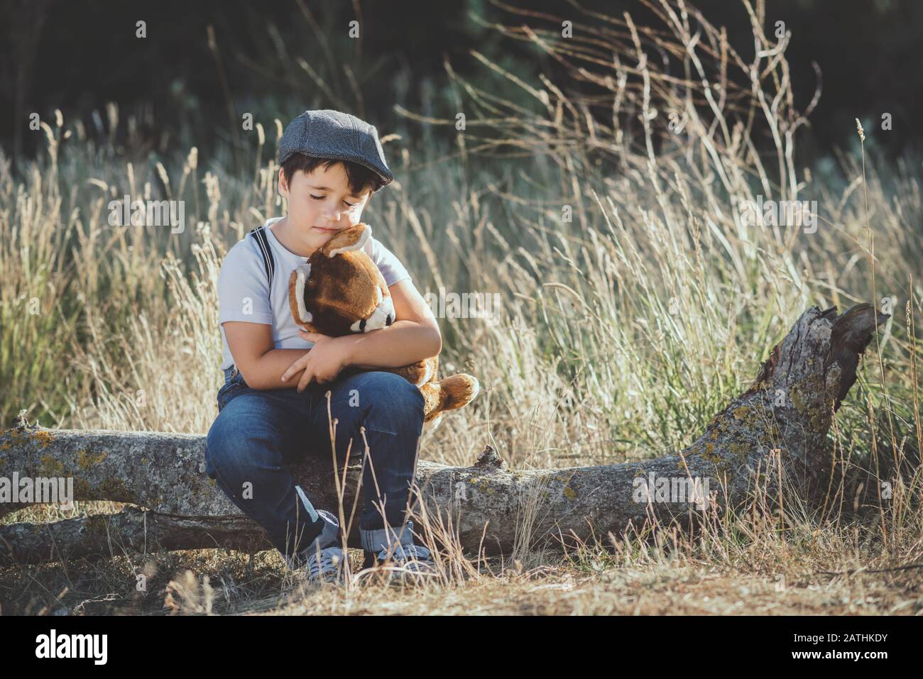Child hugging his teddy bear outdoor Stock Photo - Alamy