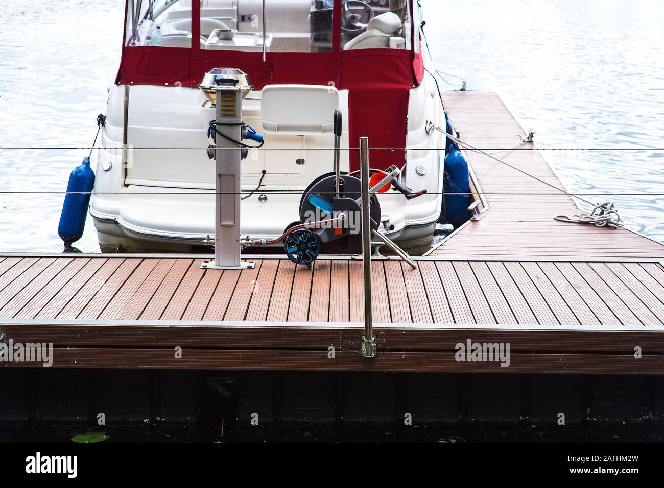 A mooring with a mooring line tied around it with boats and ships in ...