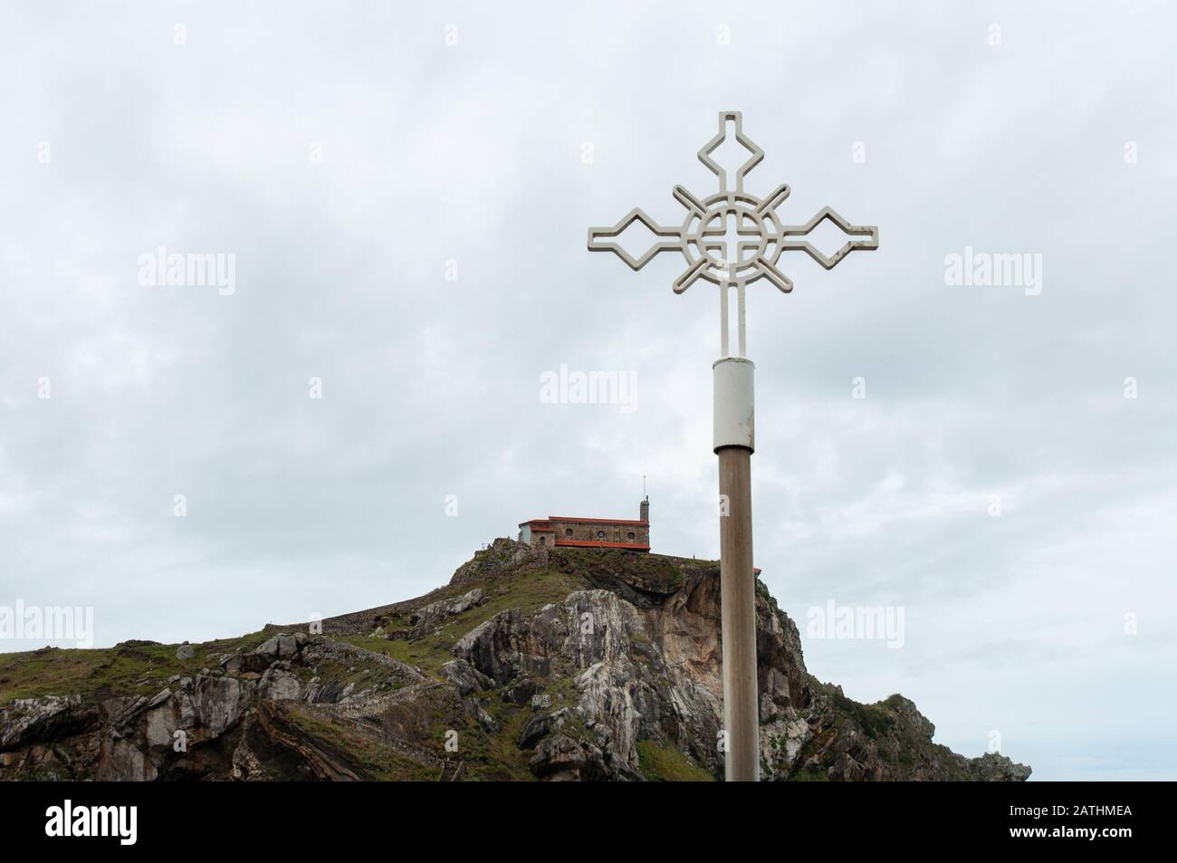 Religious cross and in the background the chapel of San Juan de ...