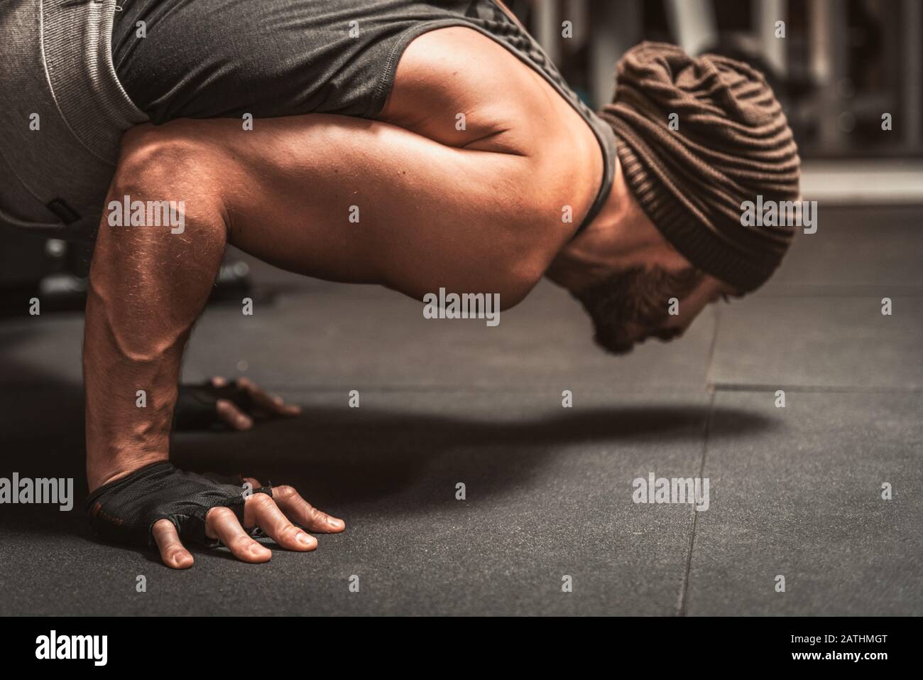 A bearded sporty man in the gym is doing Yoga exercises. Man doing the ...