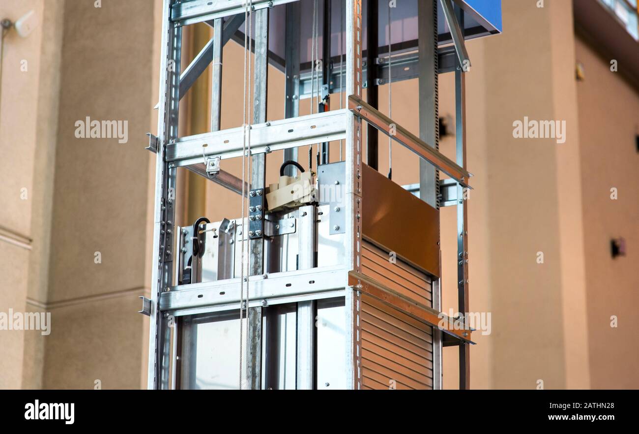 Glass elevator ,Businessman taking modern glass elevator to the upper ...