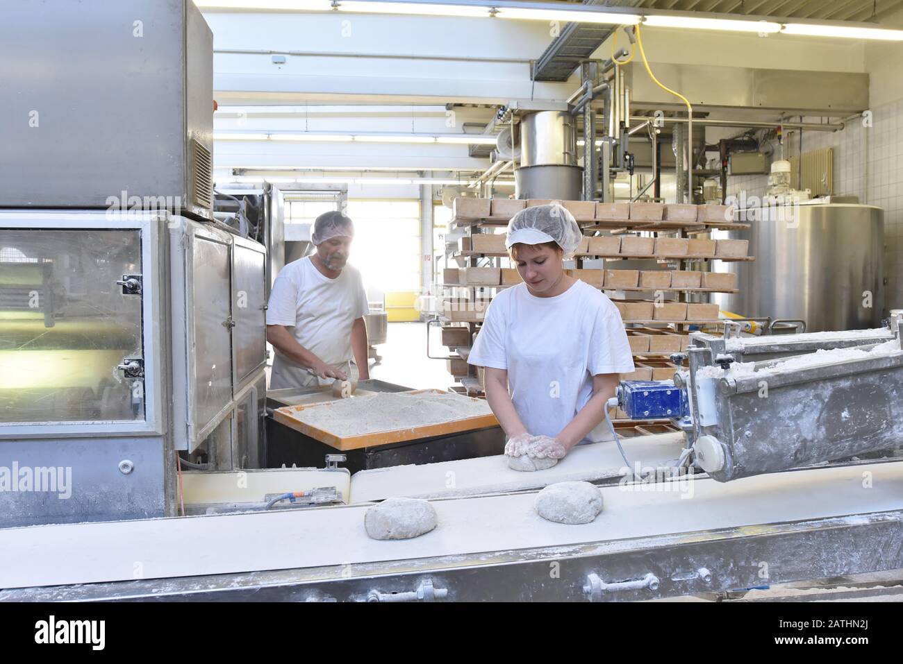 Worker in a large bakery - industrial production of bakery products on ...
