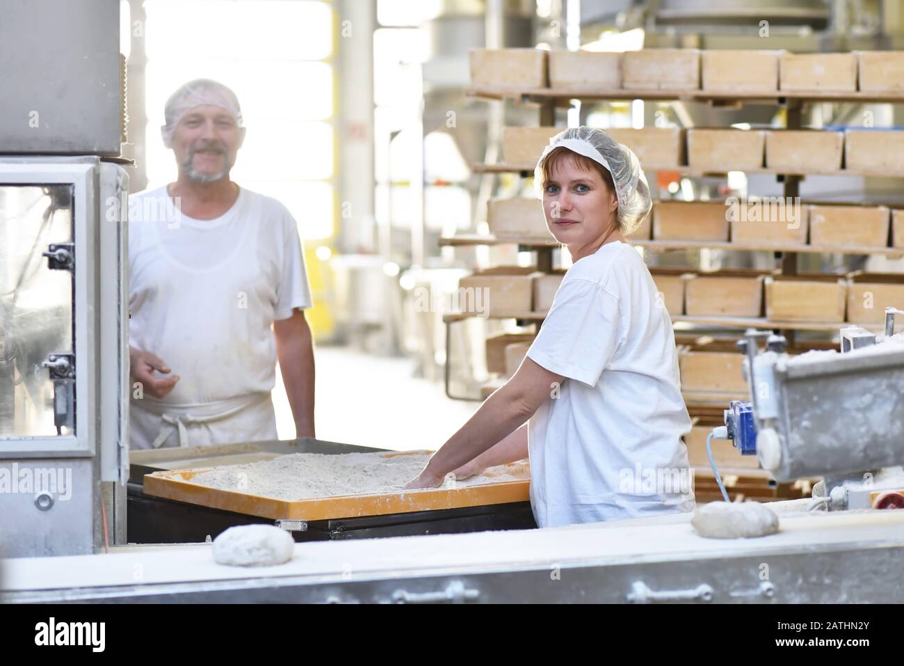 Worker in a large bakery - industrial production of bakery products on ...