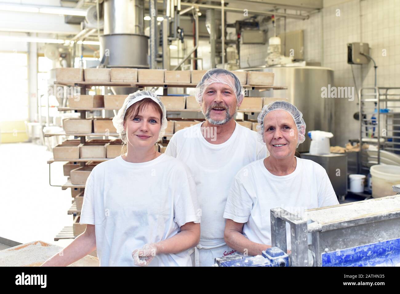 Worker in a large bakery - industrial production of bakery products on ...